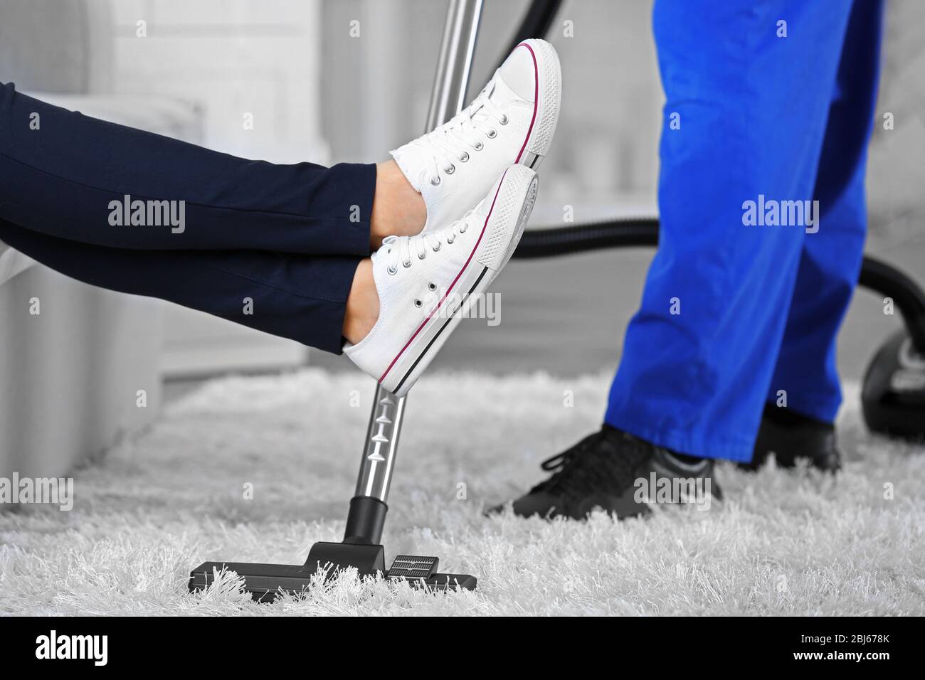 Cleaning concept - man cleaning the room with carpet sweeper, close up ...