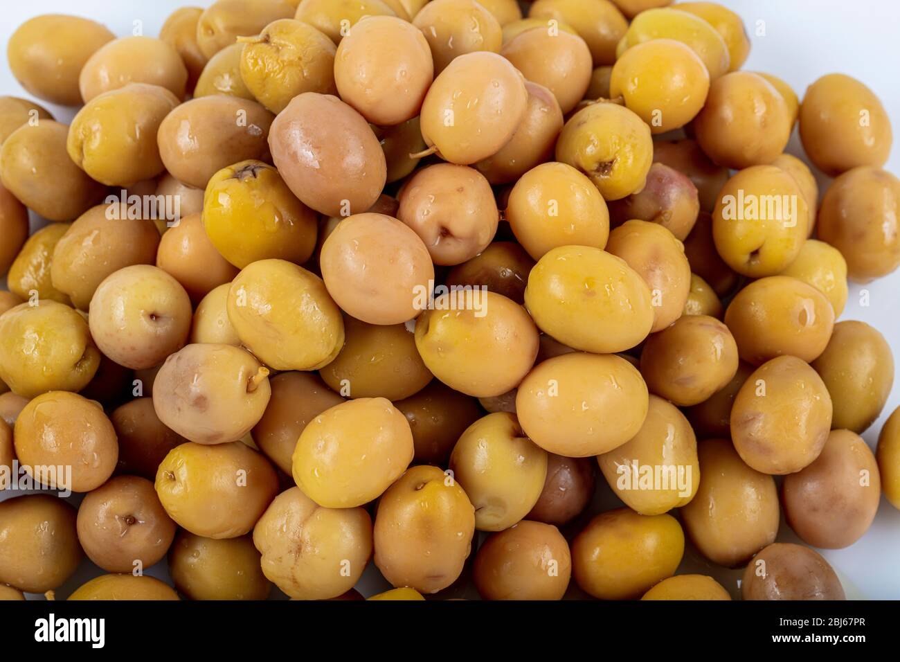 Marinated green mediterranean olives on white background Stock Photo ...