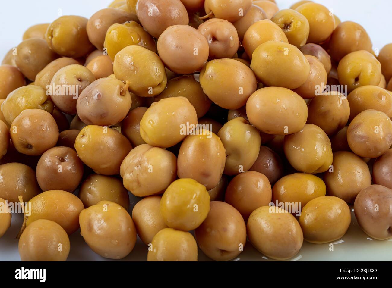 Marinated green mediterranean olives on white background Stock Photo ...