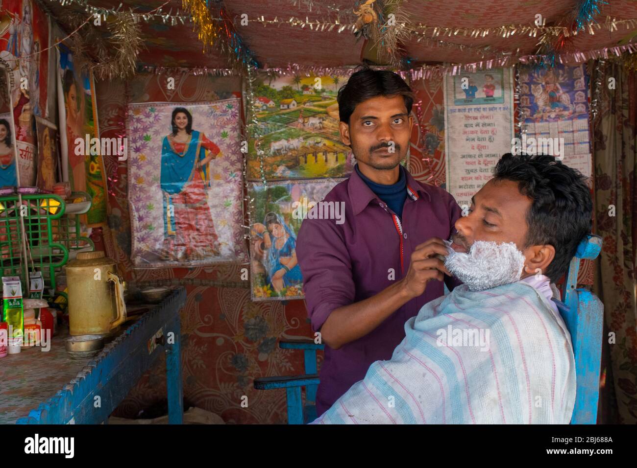 barber shaving a customer, rural, India Stock Photo - Alamy