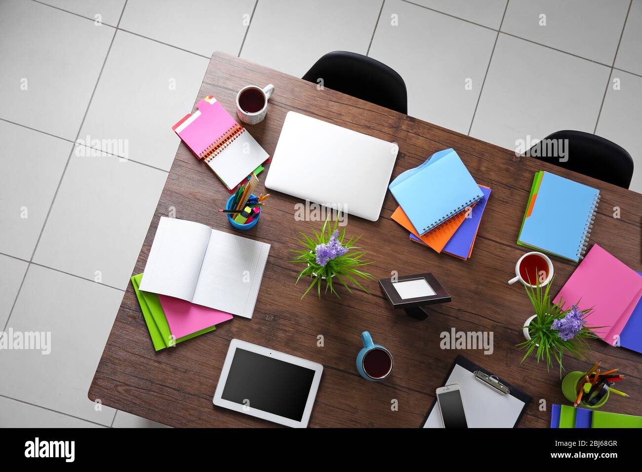 Session concept. Table with tablet, laptop, papers and cups of tea. Top ...
