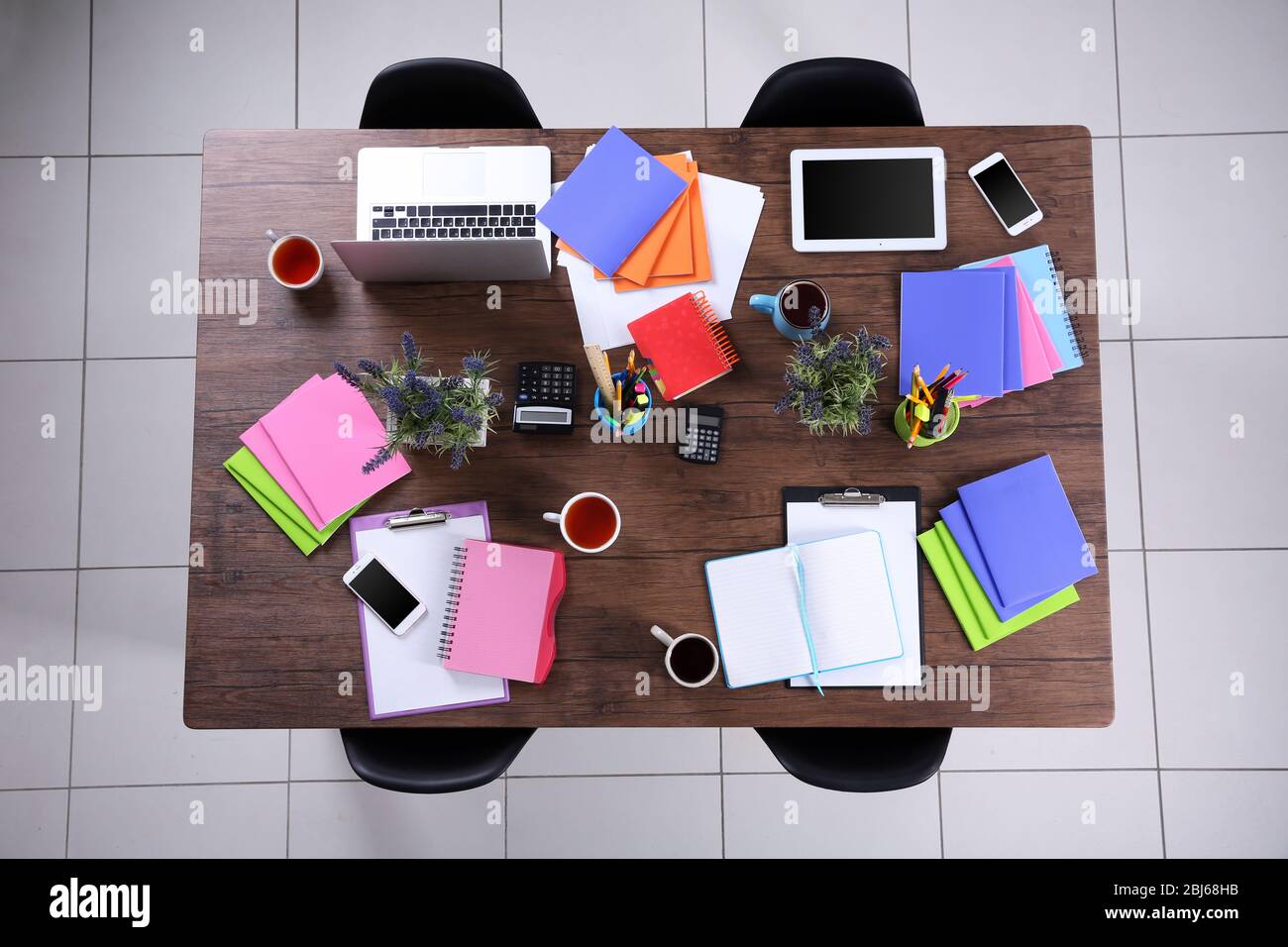 Session concept. Table with tablet, laptop, papers and cups of tea. Top ...