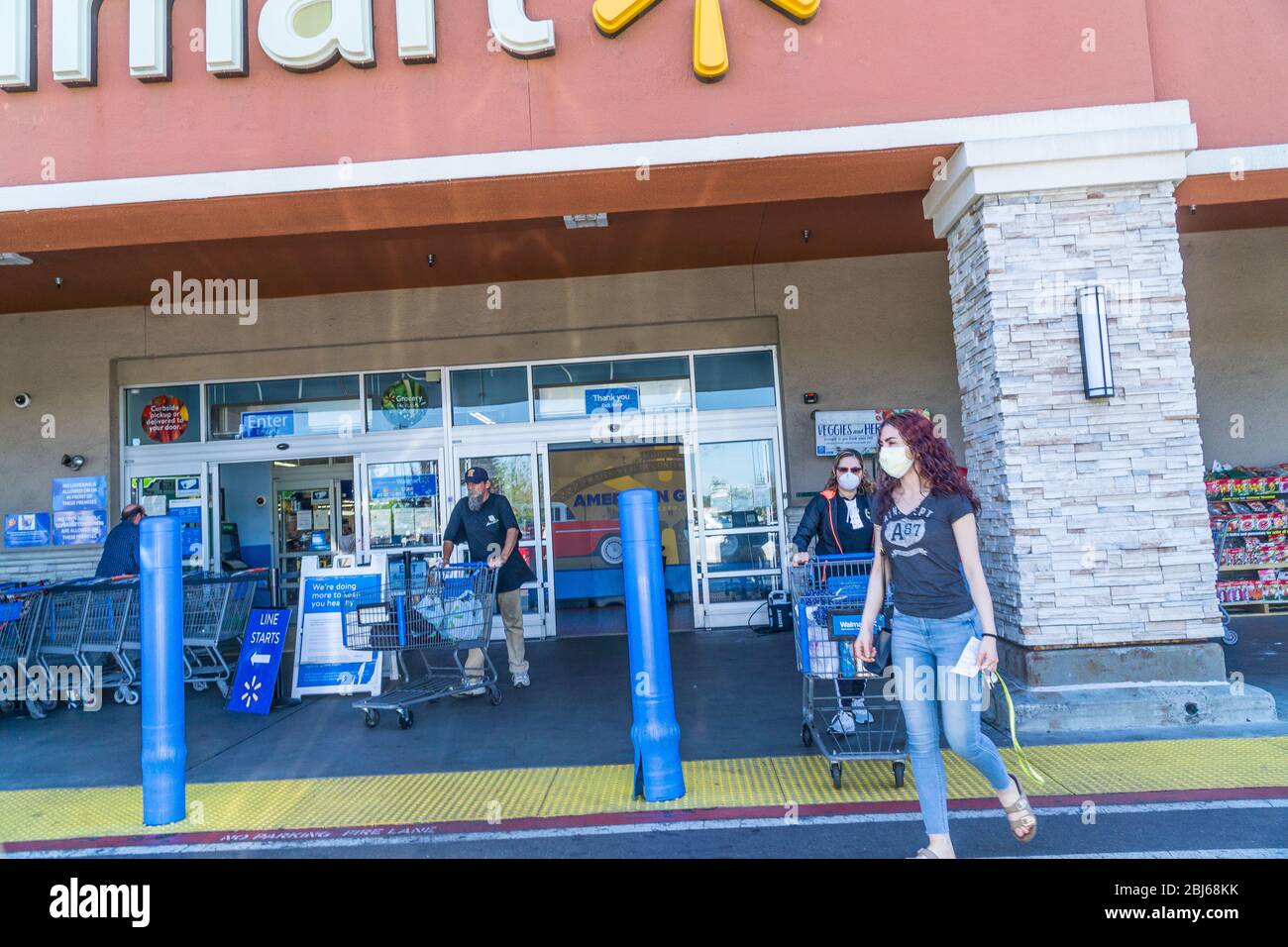 Customers leave the Walmart in Modesto California with their masks on ...