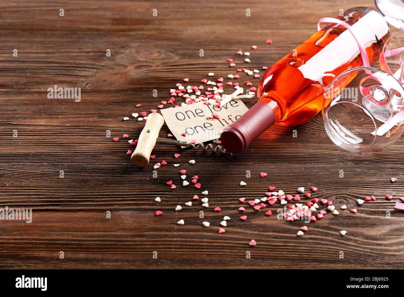 One love, one life concept - wine bottle and glasses with hearts around ...