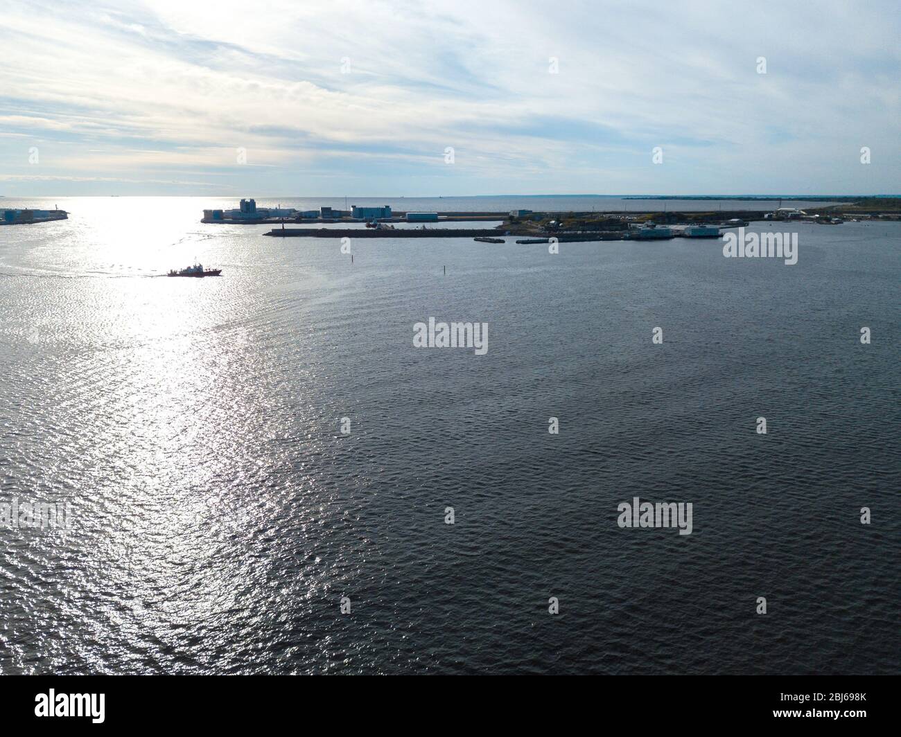 Aerial view of the green red tugboat going along the Finnish Gulf Stock ...