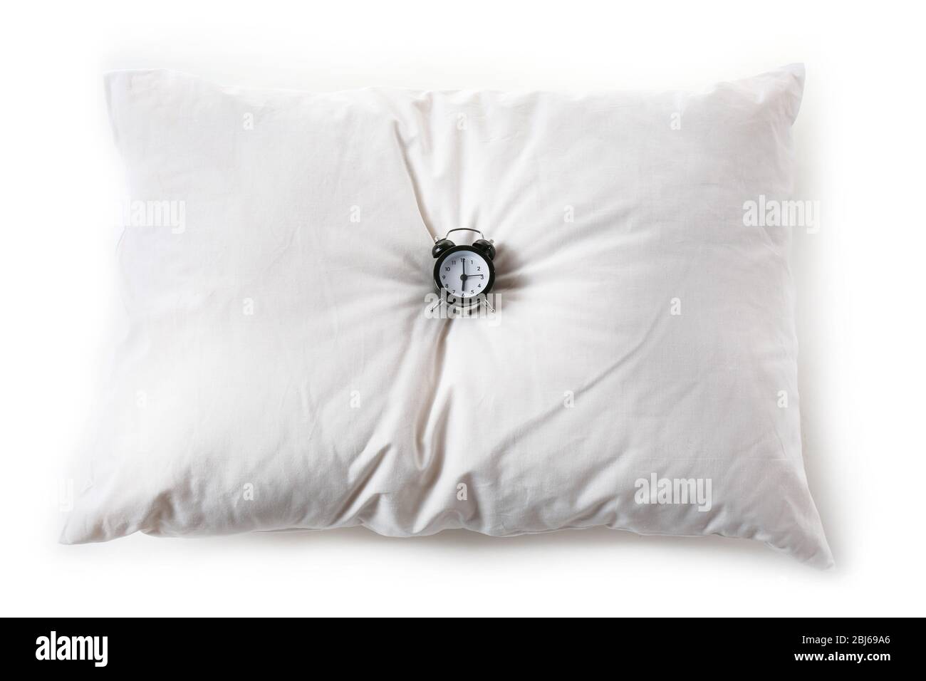 Alarm clock on pillow, isolated on white Stock Photo - Alamy