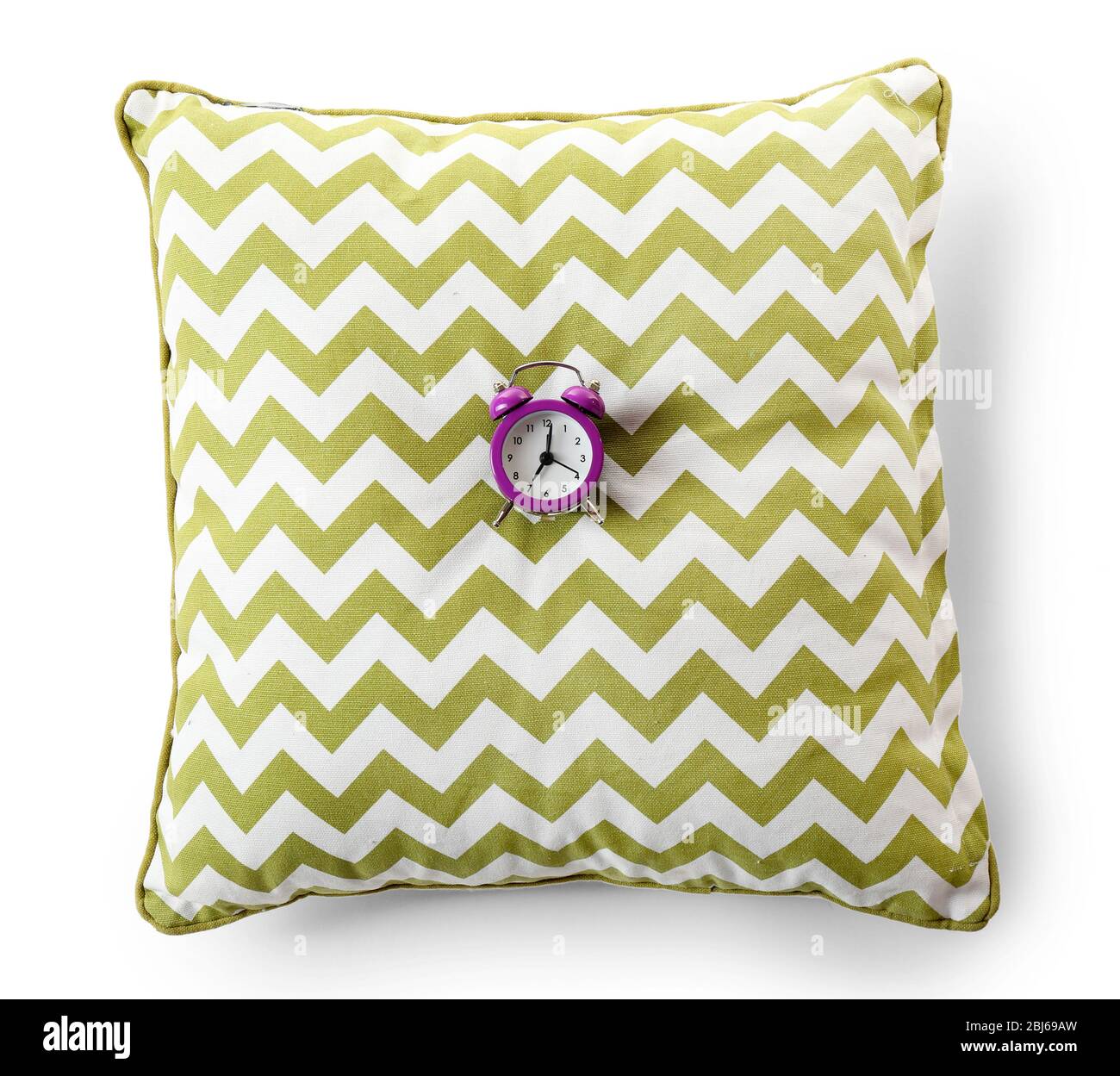 Alarm clock on pillow, isolated on white Stock Photo - Alamy