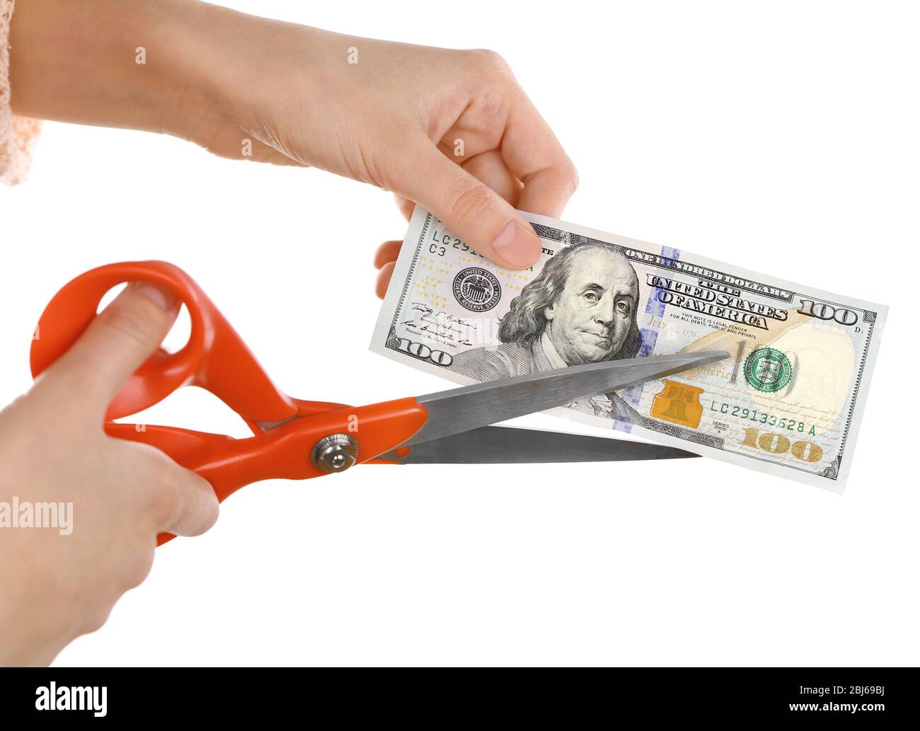 Hands with scissors cutting dollar banknote, isolated on white Stock ...