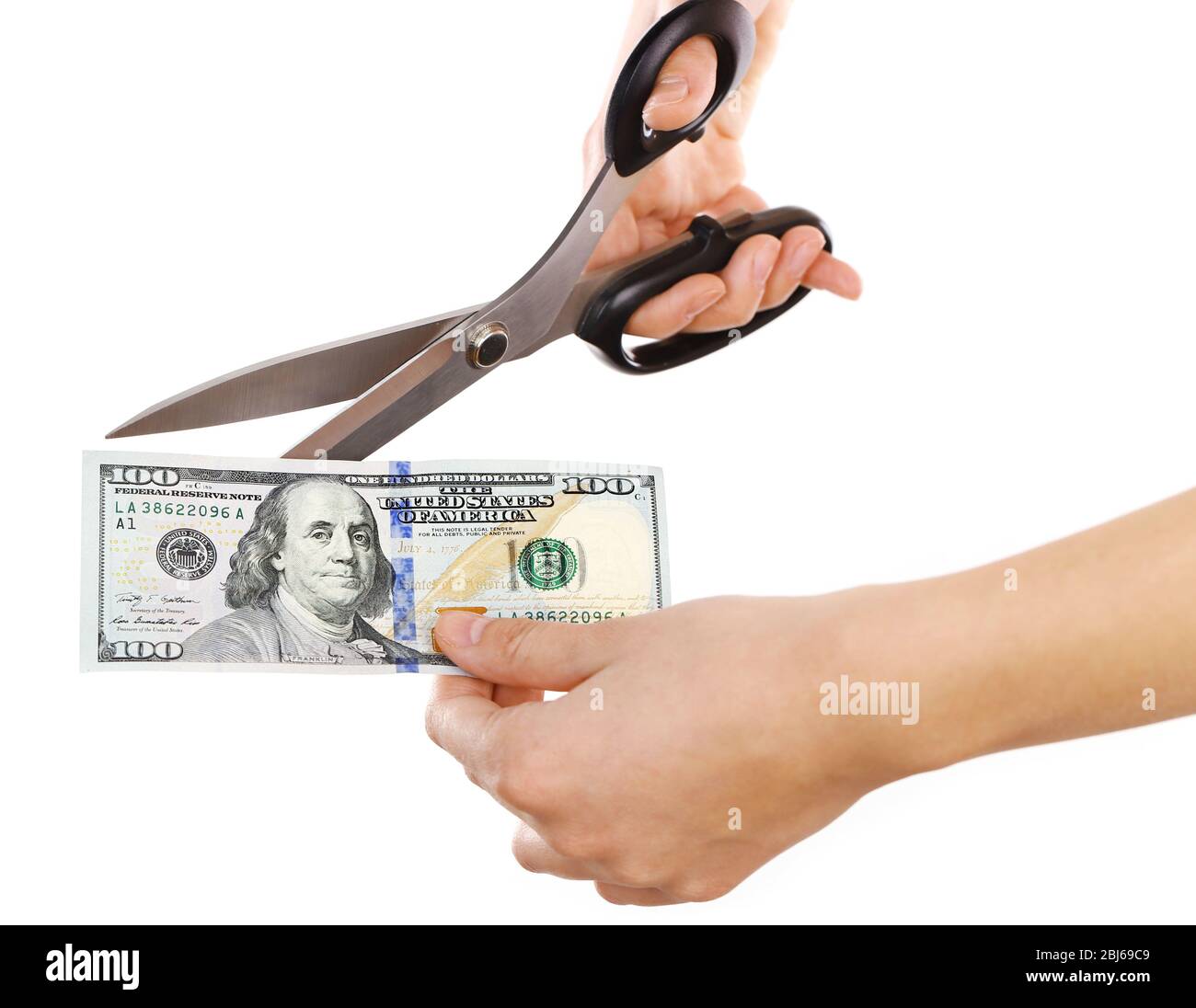 Hands with scissors cutting dollar banknote, isolated on white Stock ...
