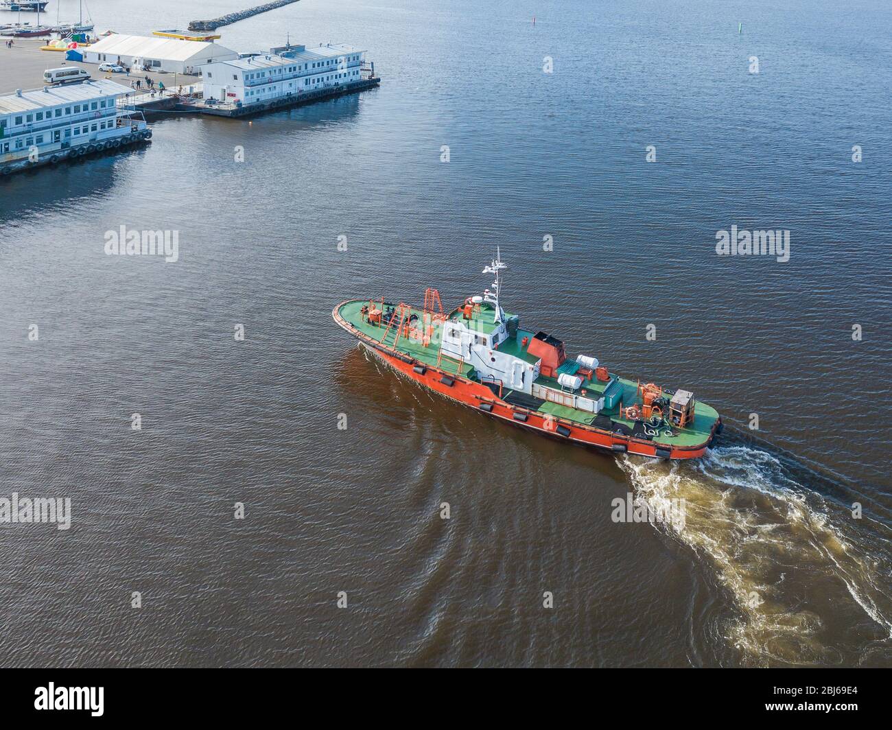 Aerial view of the green red tugboat going along the Finnish Gulf Stock ...