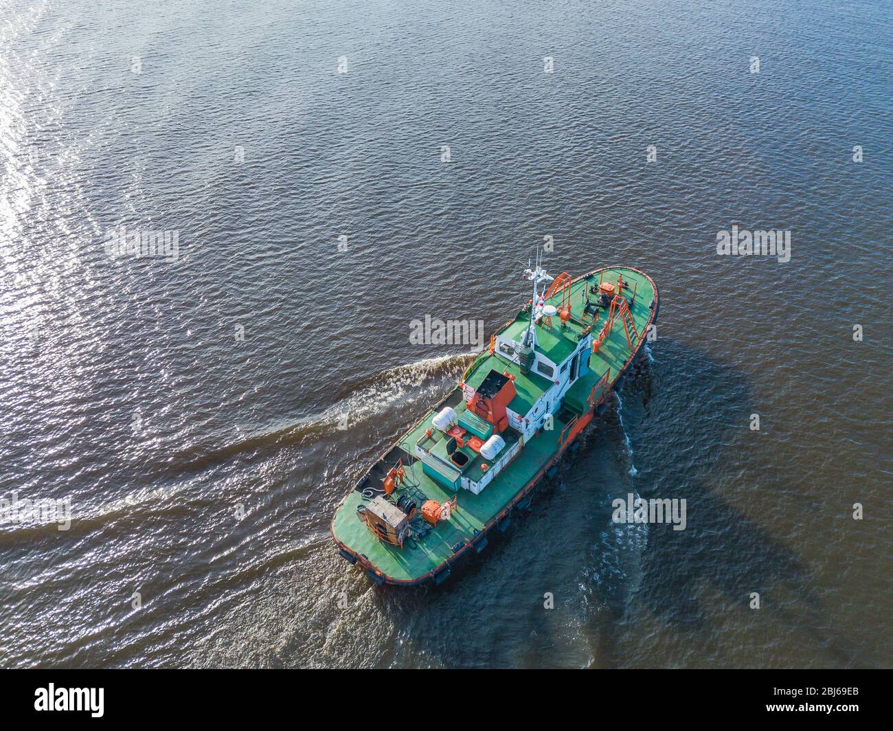 Aerial view of the green red tugboat going along the Finnish Gulf Stock ...