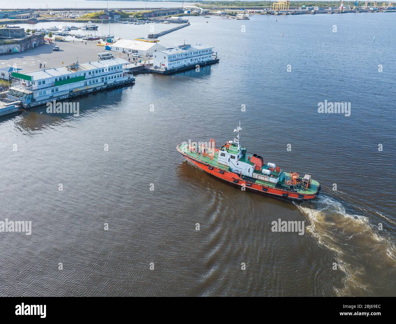 Aerial view of the green red tugboat going along the Finnish Gulf Stock ...