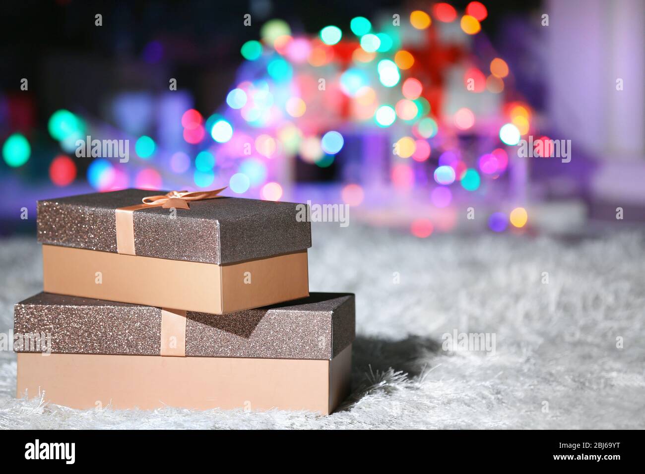 Beautiful gift boxes on the floor, close up Stock Photo - Alamy