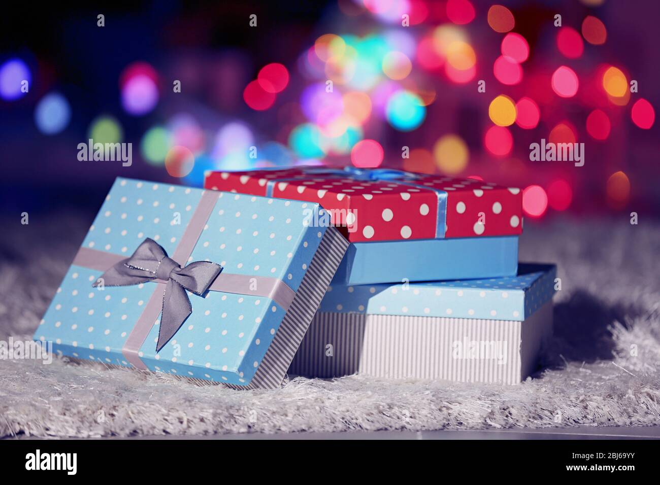 Pile of Christmas gift boxes on the floor, close up Stock Photo - Alamy