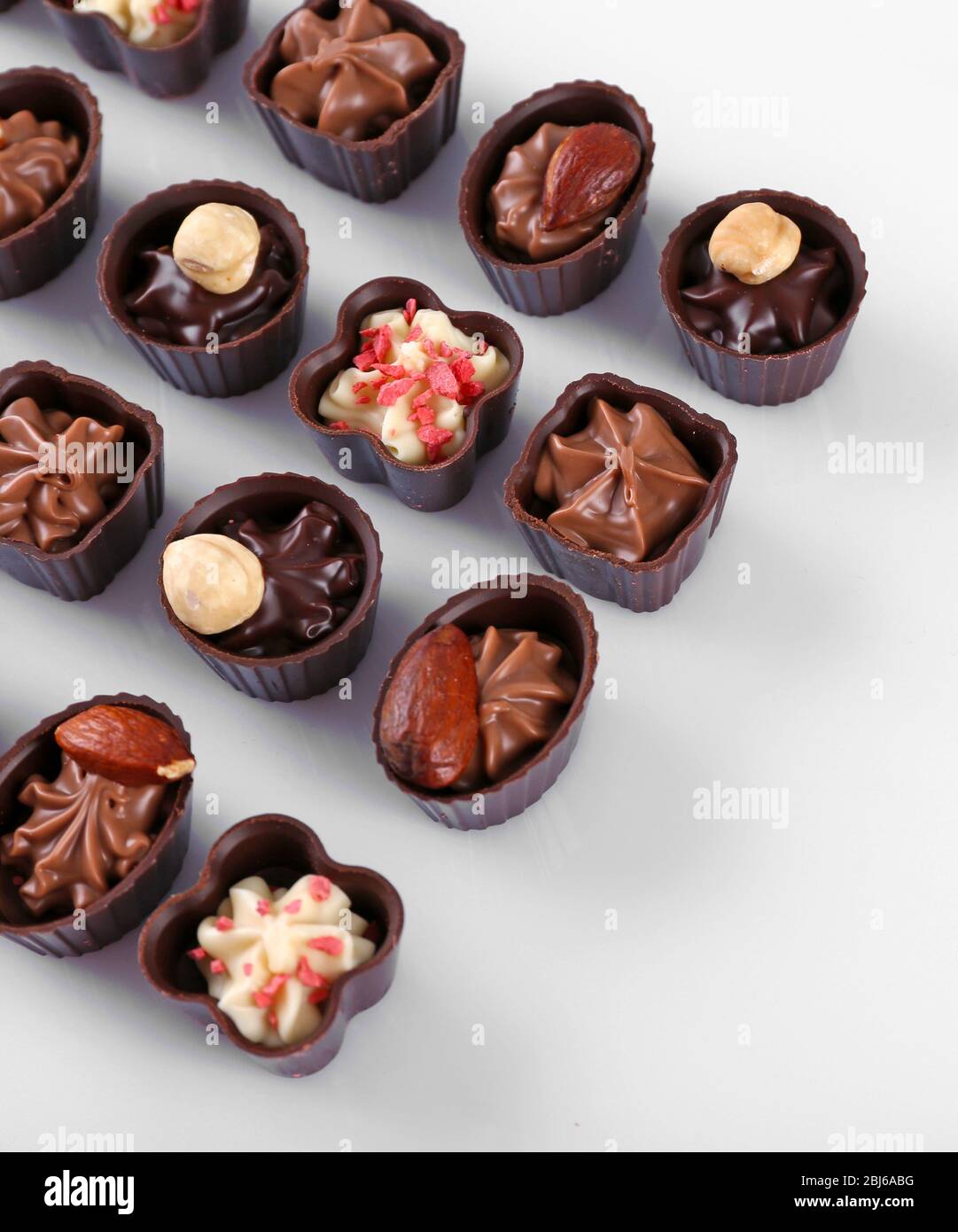 Delicious chocolate candies on white background Stock Photo - Alamy