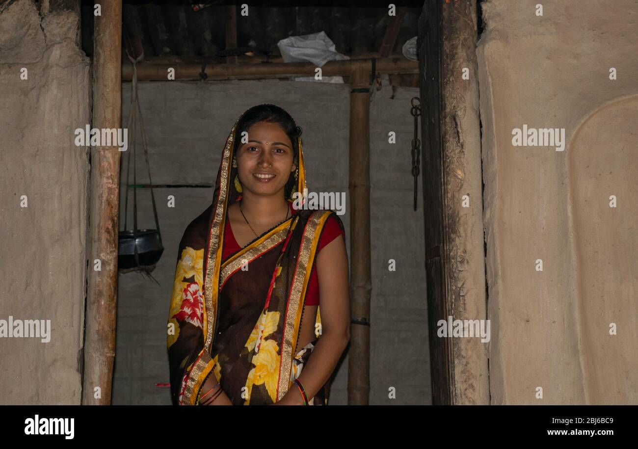 Rural woman standing at doorstep of house in village, India Stock Photo ...