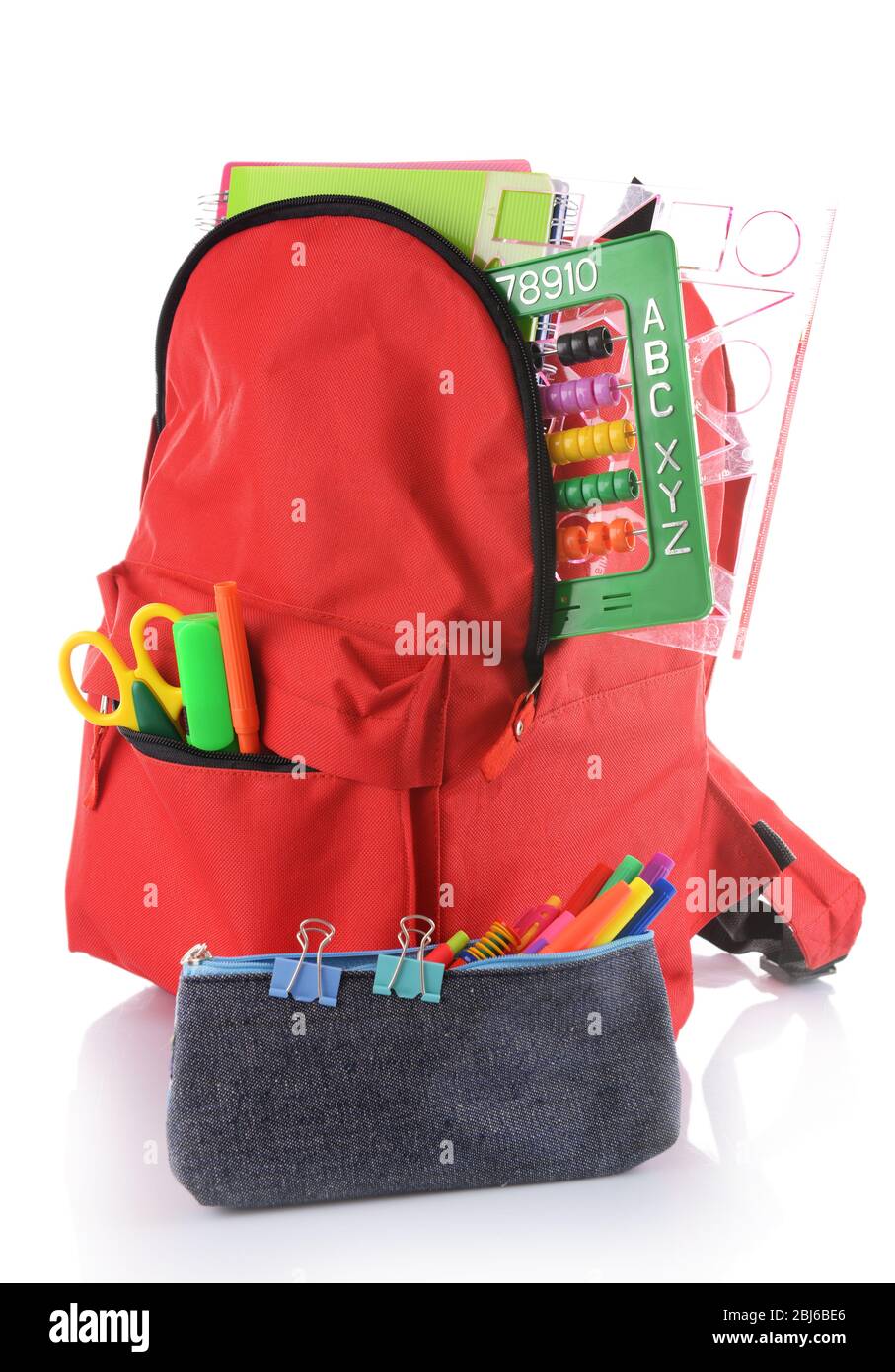 Red backpack with colourful stationary and pencil case isolated on ...
