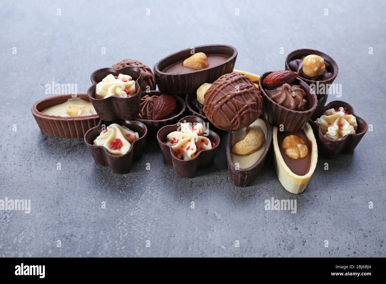Chocolate sweets on dark grey background Stock Photo - Alamy