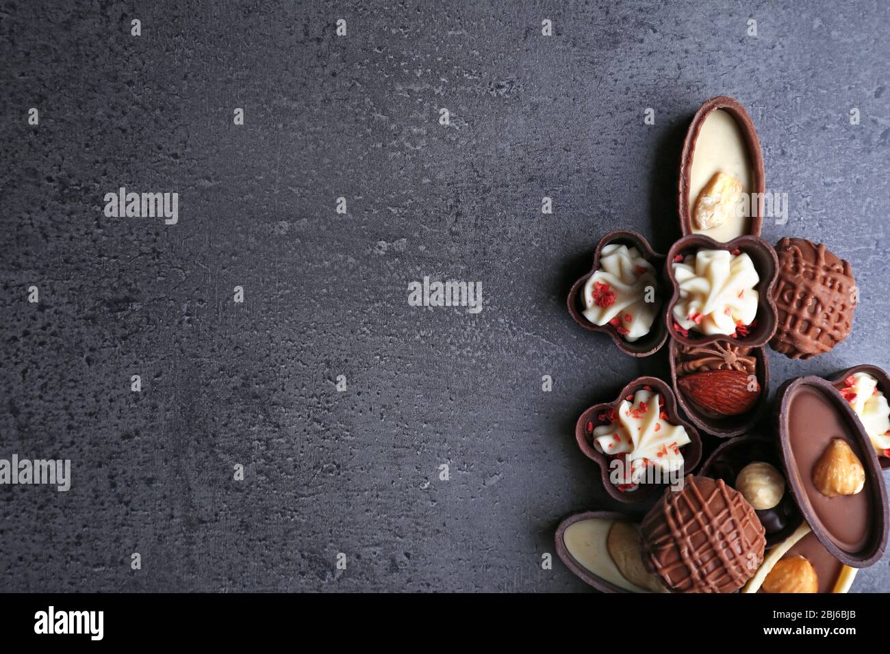 Chocolate sweets on dark grey background Stock Photo - Alamy