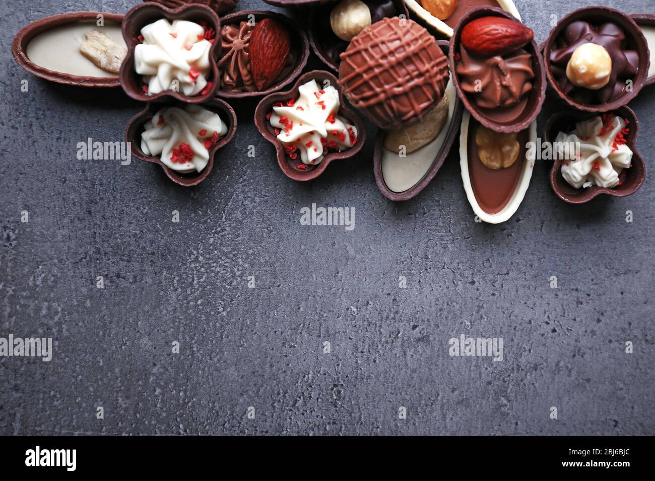 Chocolate sweets on dark grey background Stock Photo - Alamy