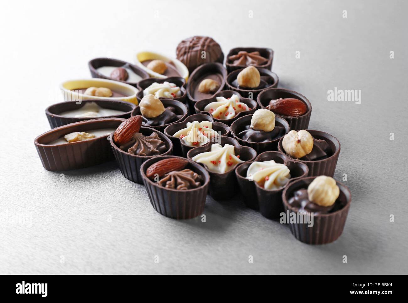 Chocolate sweets on dark grey background Stock Photo - Alamy