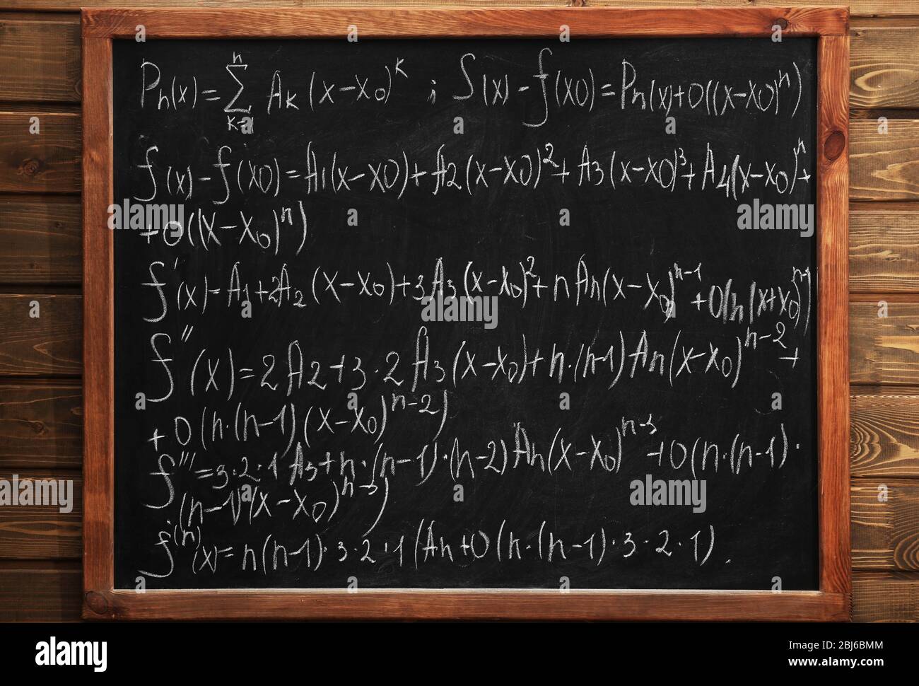 School blackboard with formulas on a brick wall Stock Photo - Alamy