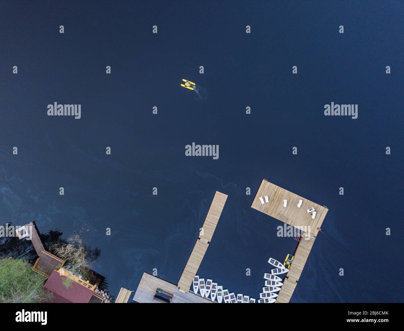 Aerial view of a man who swims on a lake on a pedal catamaran, a water ...