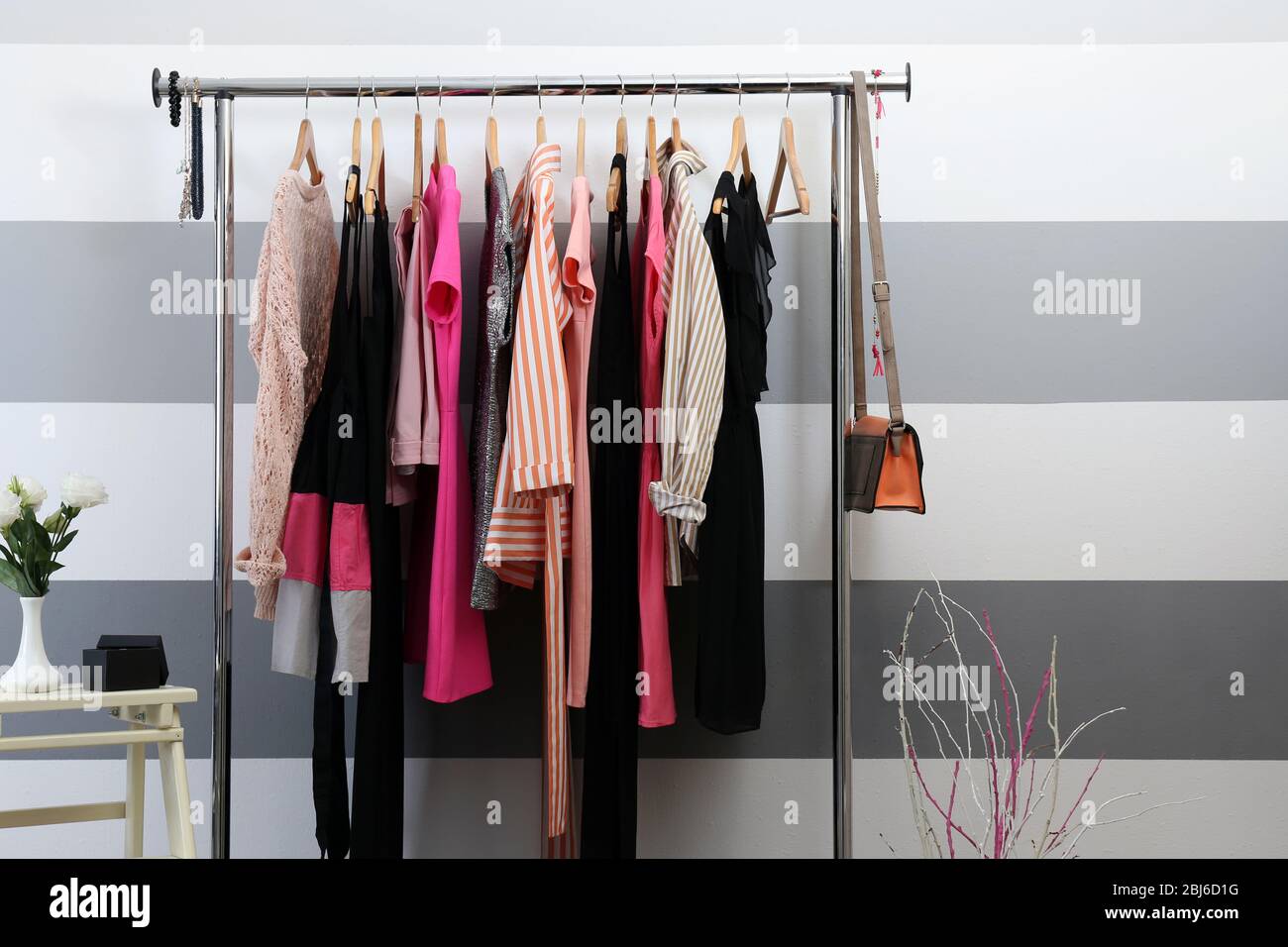 Female clothes on hangers in a room Stock Photo - Alamy