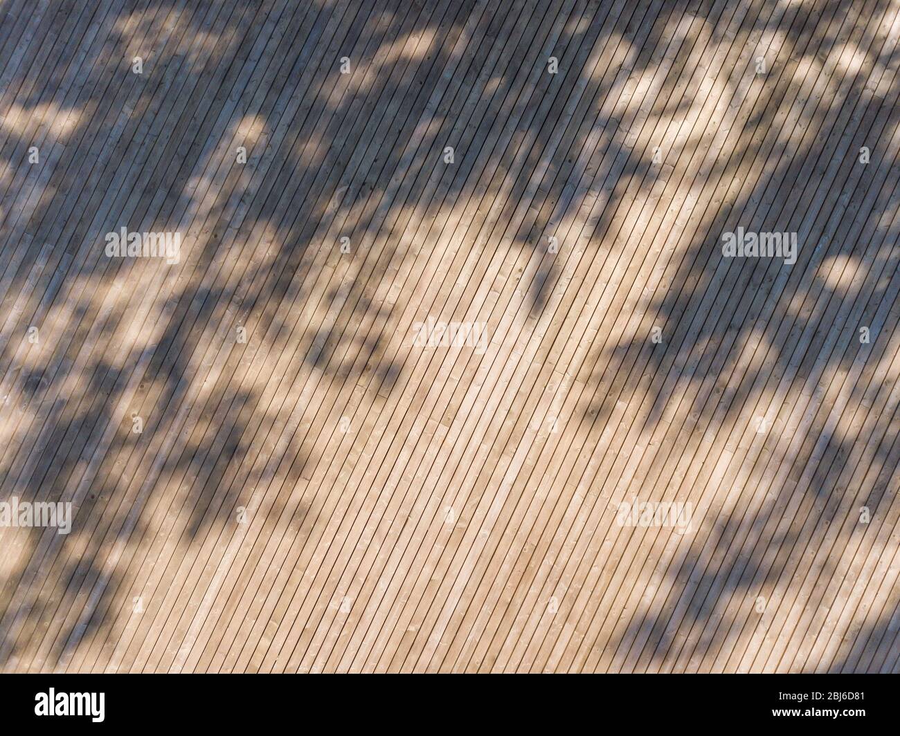Aerial view of a wooden platform with shadows from trees Stock Photo ...