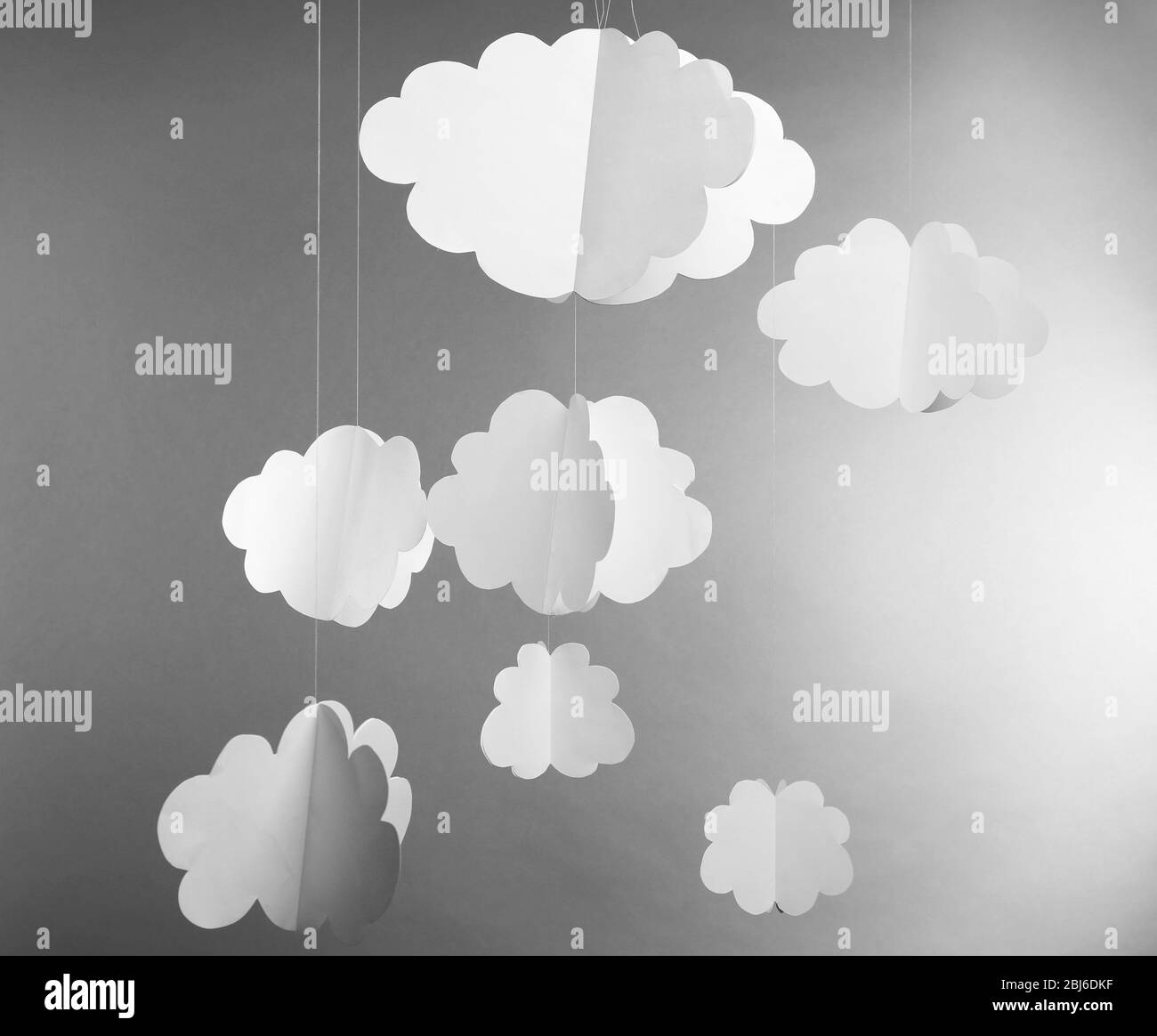 Paper clouds on grey background Stock Photo - Alamy
