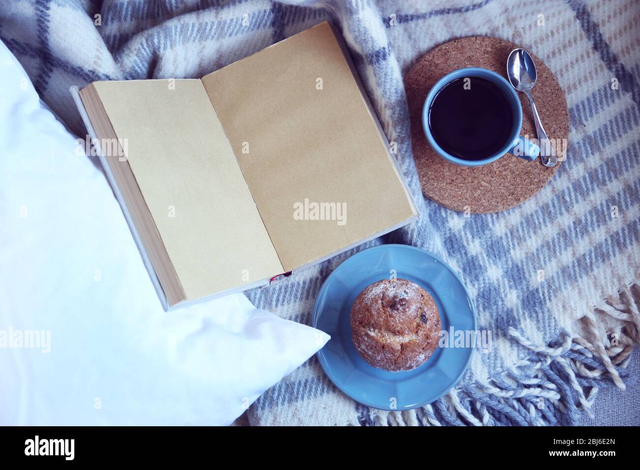 Open book, plaid and coffee on sofa. Top view Stock Photo - Alamy
