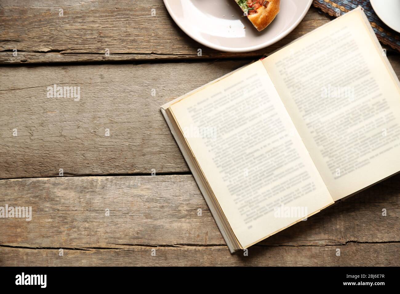 Open book and snack on wooden table background Stock Photo - Alamy