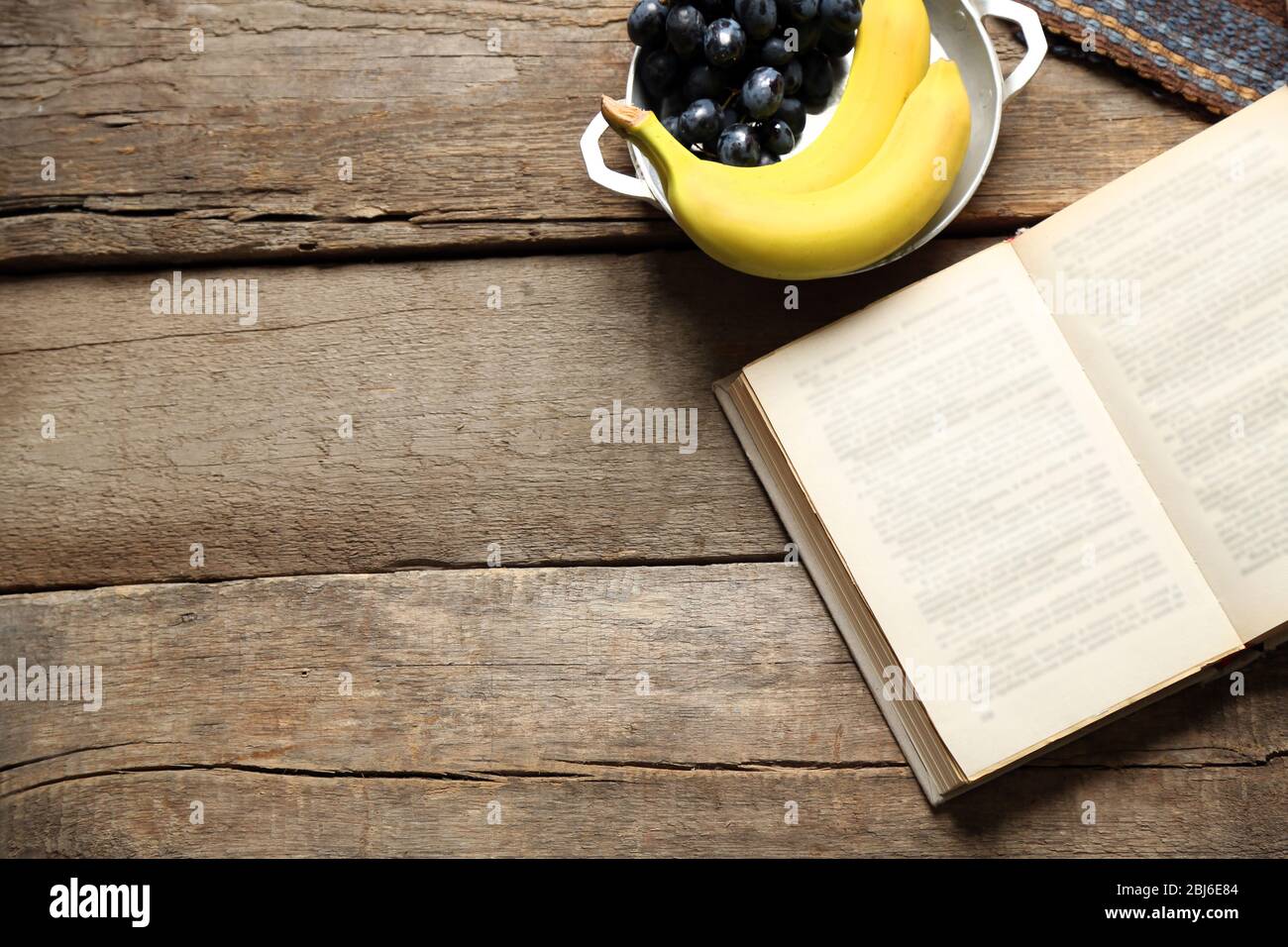 Open book and snack on wooden table background Stock Photo - Alamy