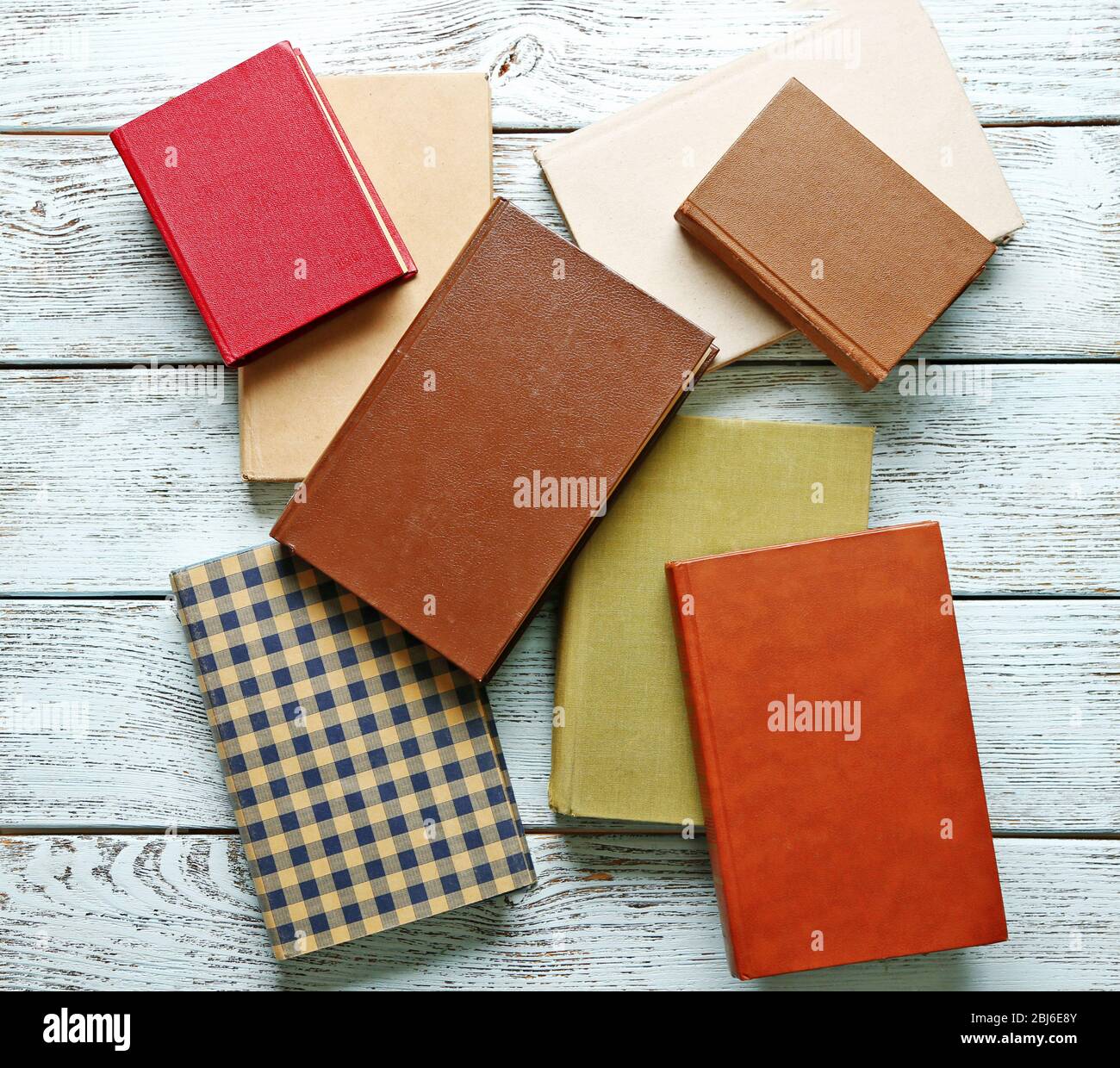 Pile of books on wooden background Stock Photo - Alamy