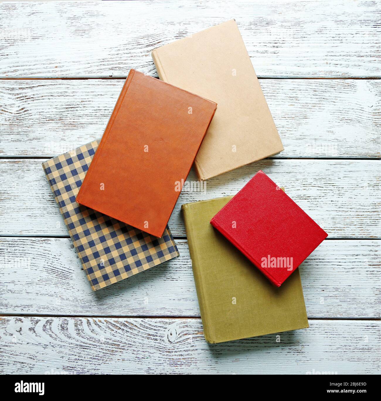 Pile of books on wooden background Stock Photo - Alamy