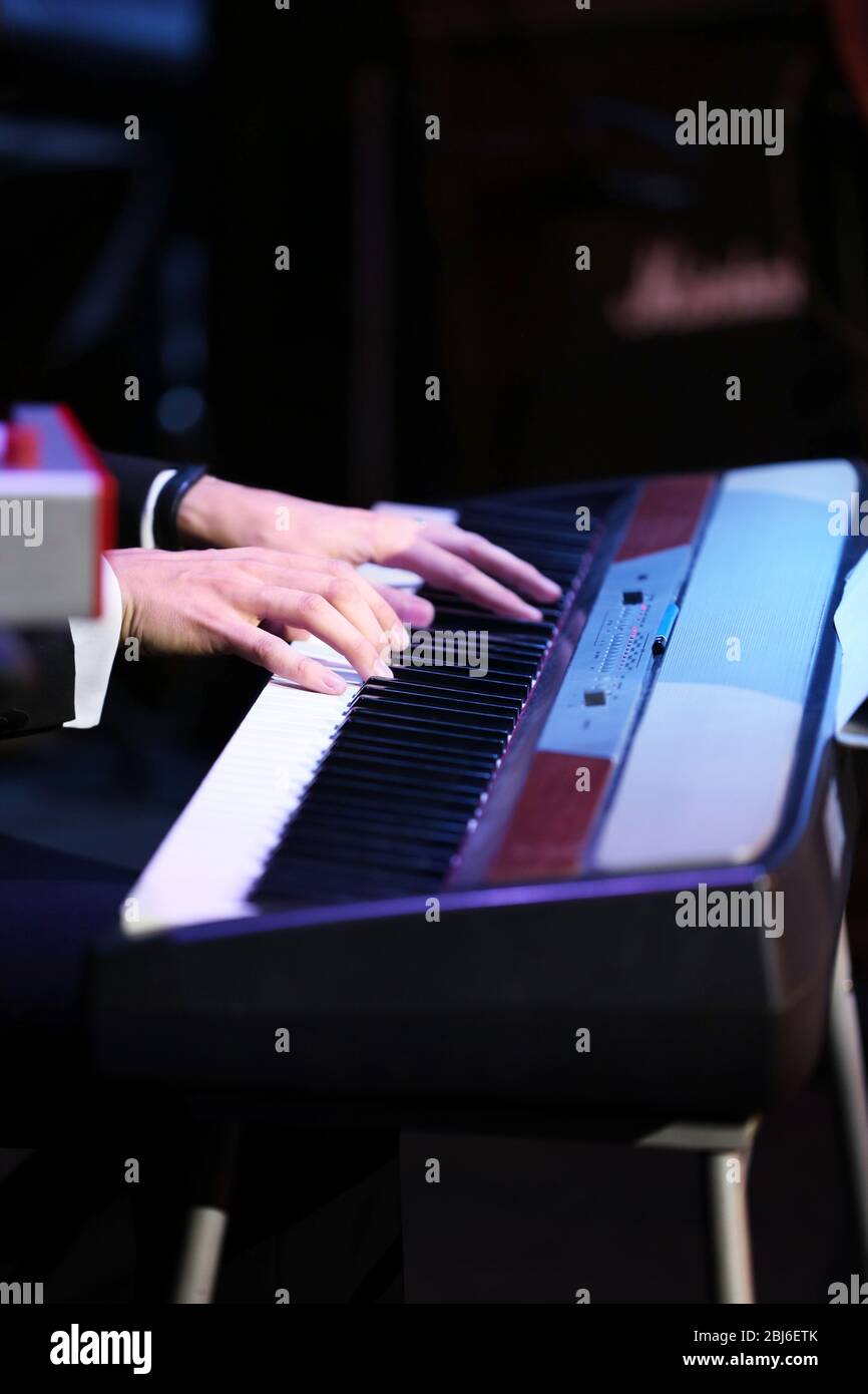 Musician playing synthesizer at concert Stock Photo - Alamy