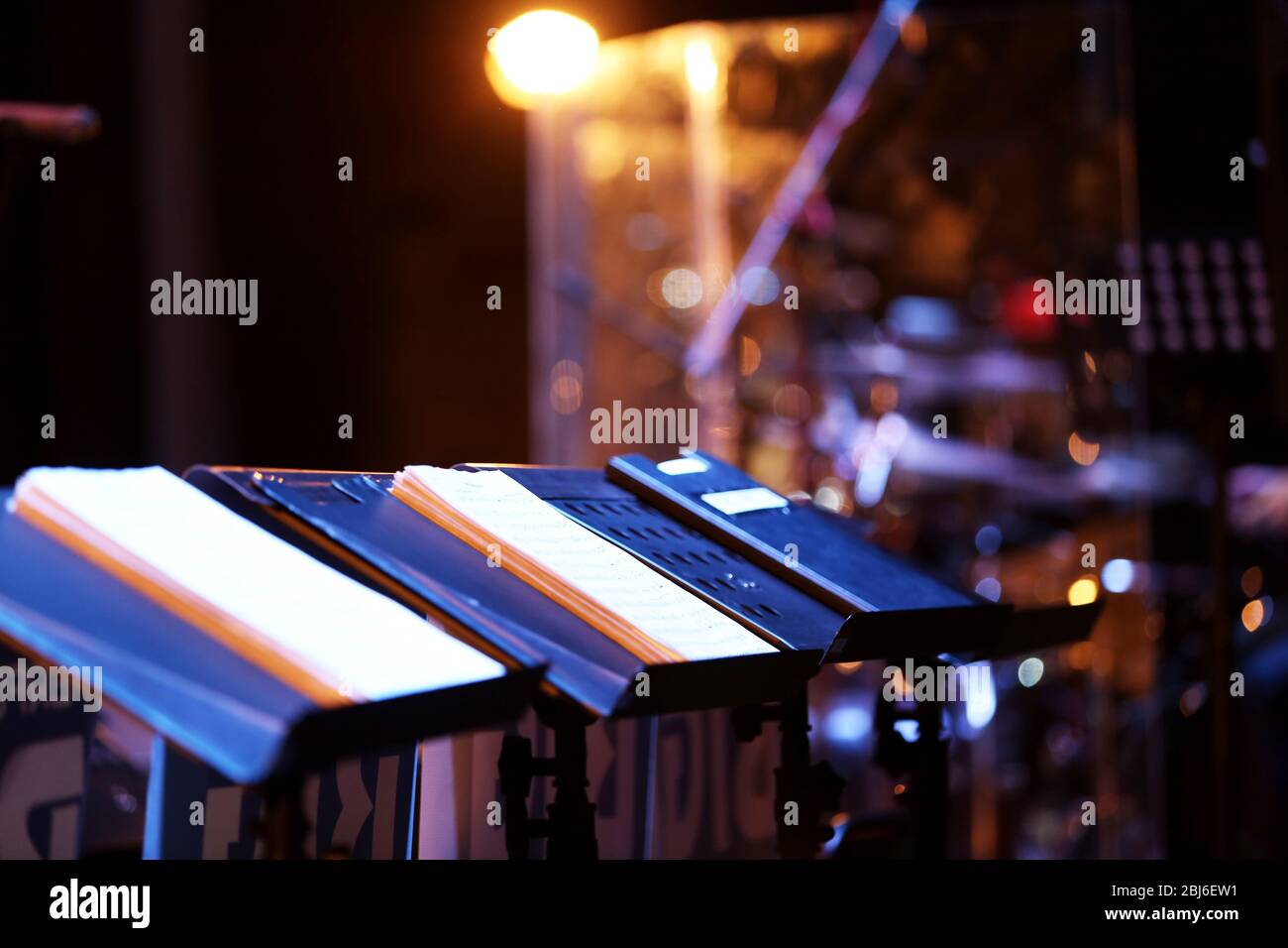 Music stands with notes on stage at concert Stock Photo - Alamy