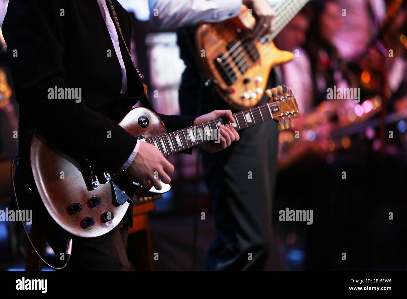 Guitarist playing the guitar at concert Stock Photo - Alamy