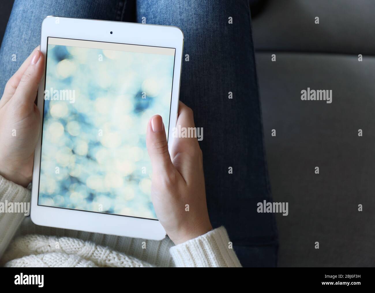 Female hand holding PC tablet on home interior background Stock Photo ...