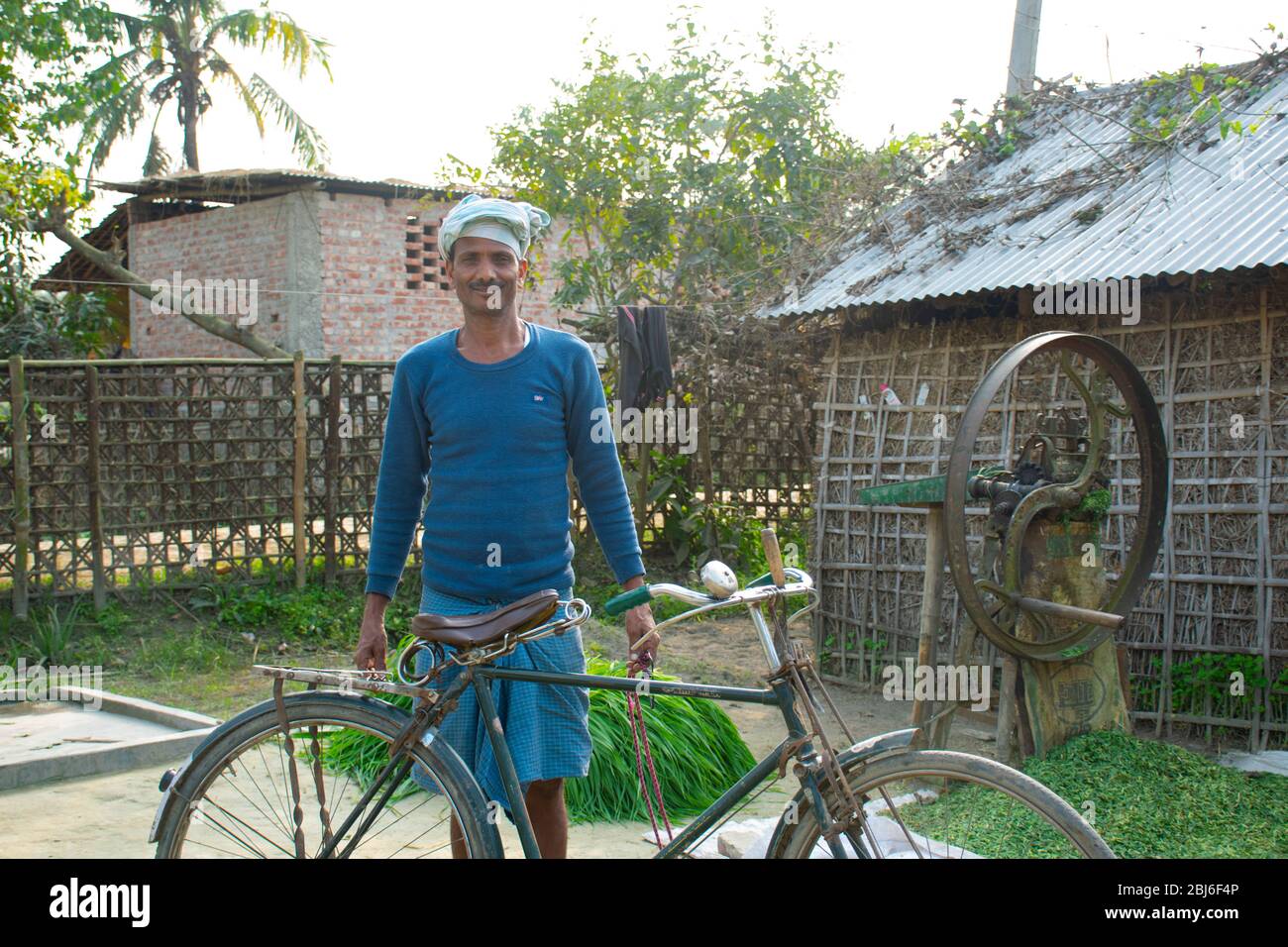 rural man standing in front of his house with cycle Stock Photo - Alamy