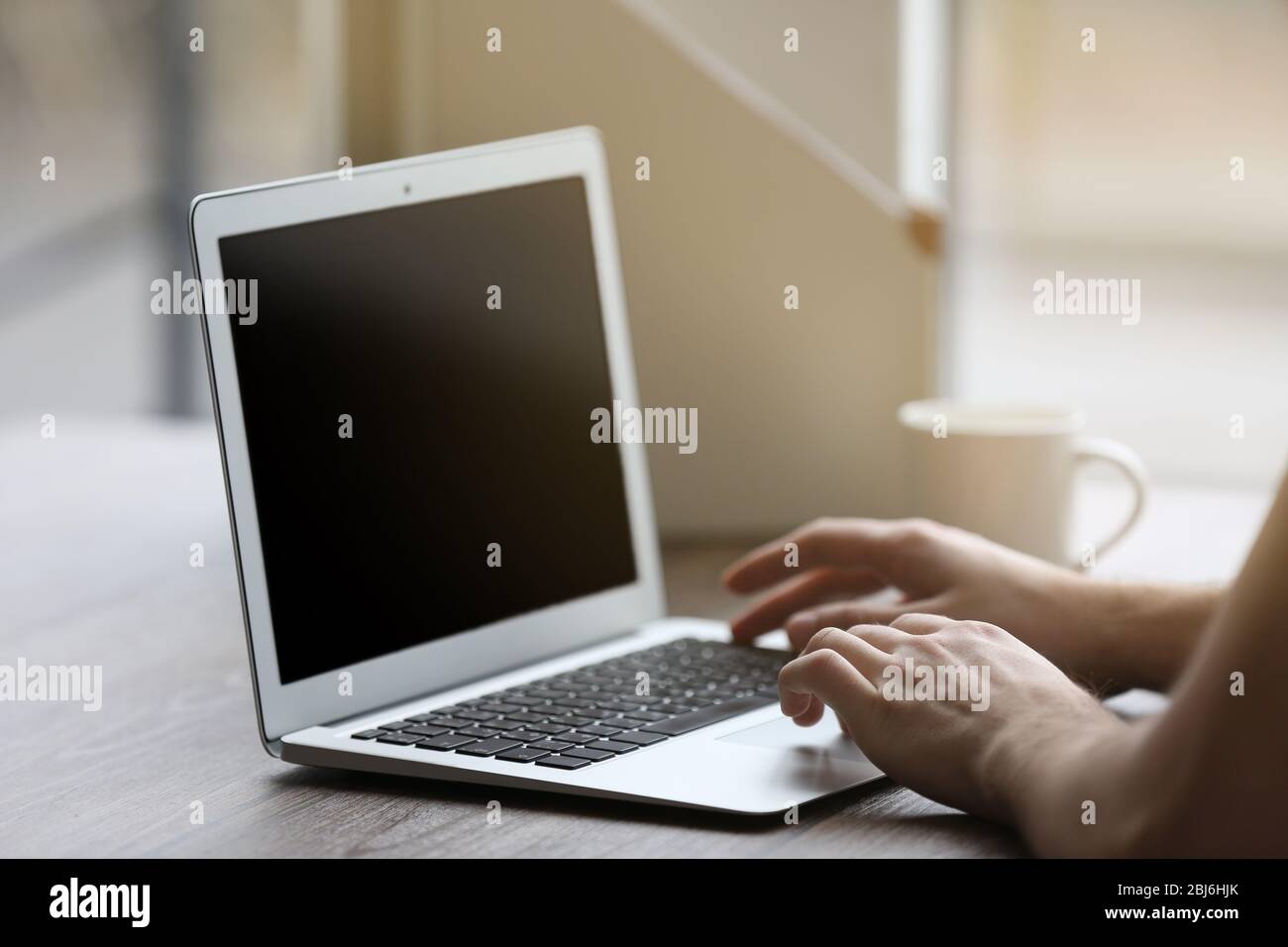 Mans hands using laptop phone hi-res stock photography and images - Alamy