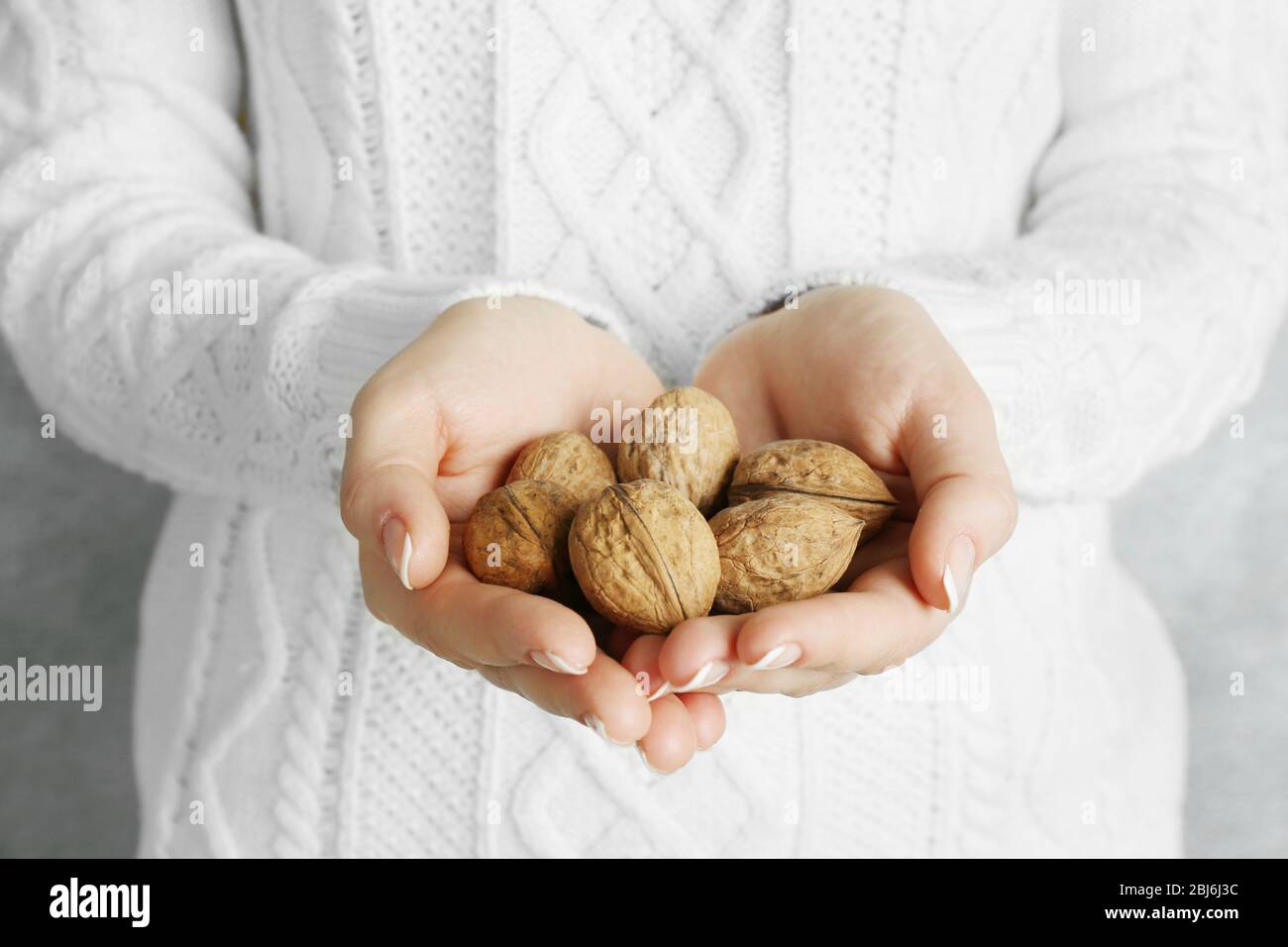 Walnuts in female hands hi-res stock photography and images - Alamy
