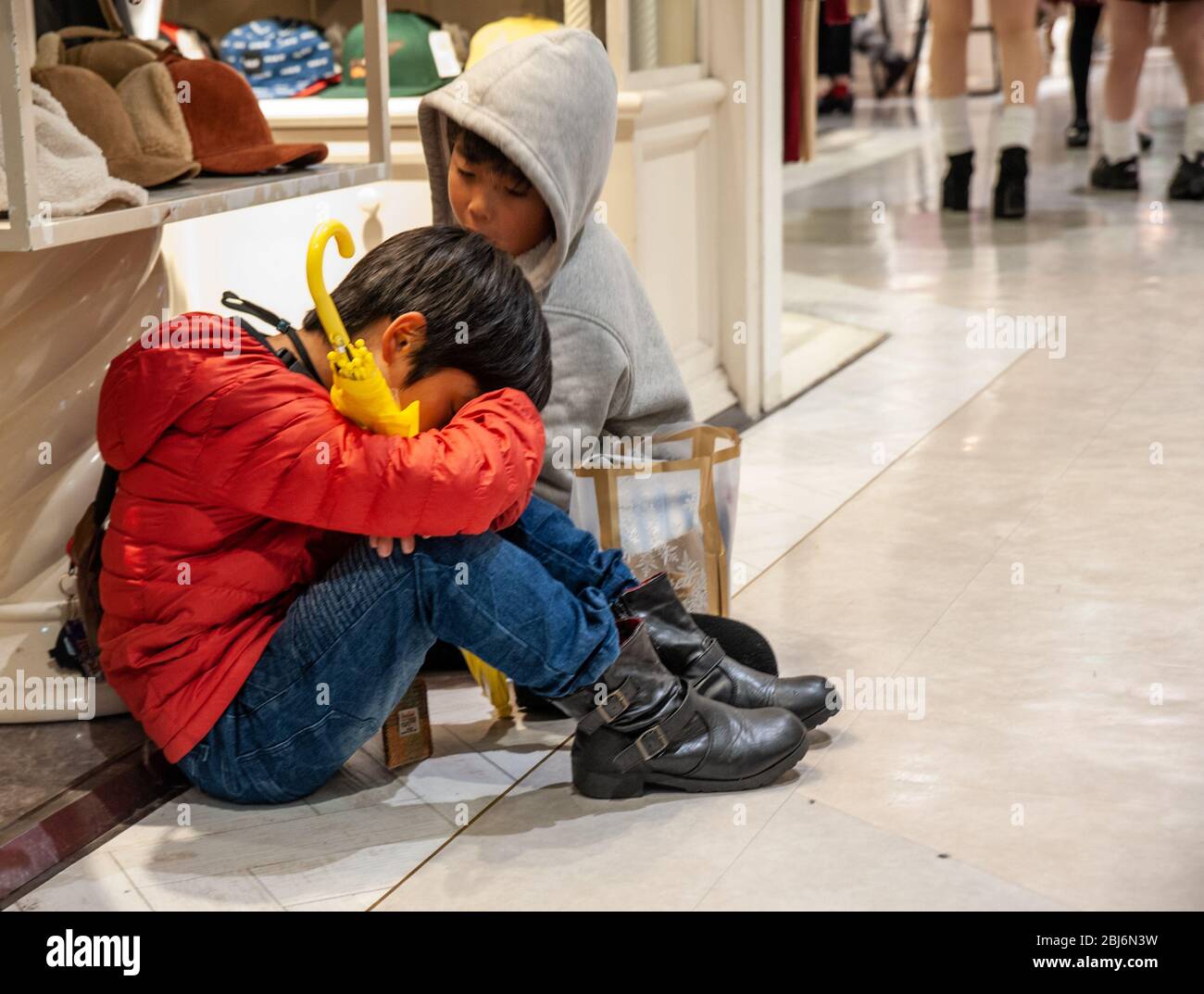 Two Japanese brothers sit on the floor waiting for their mother while ...