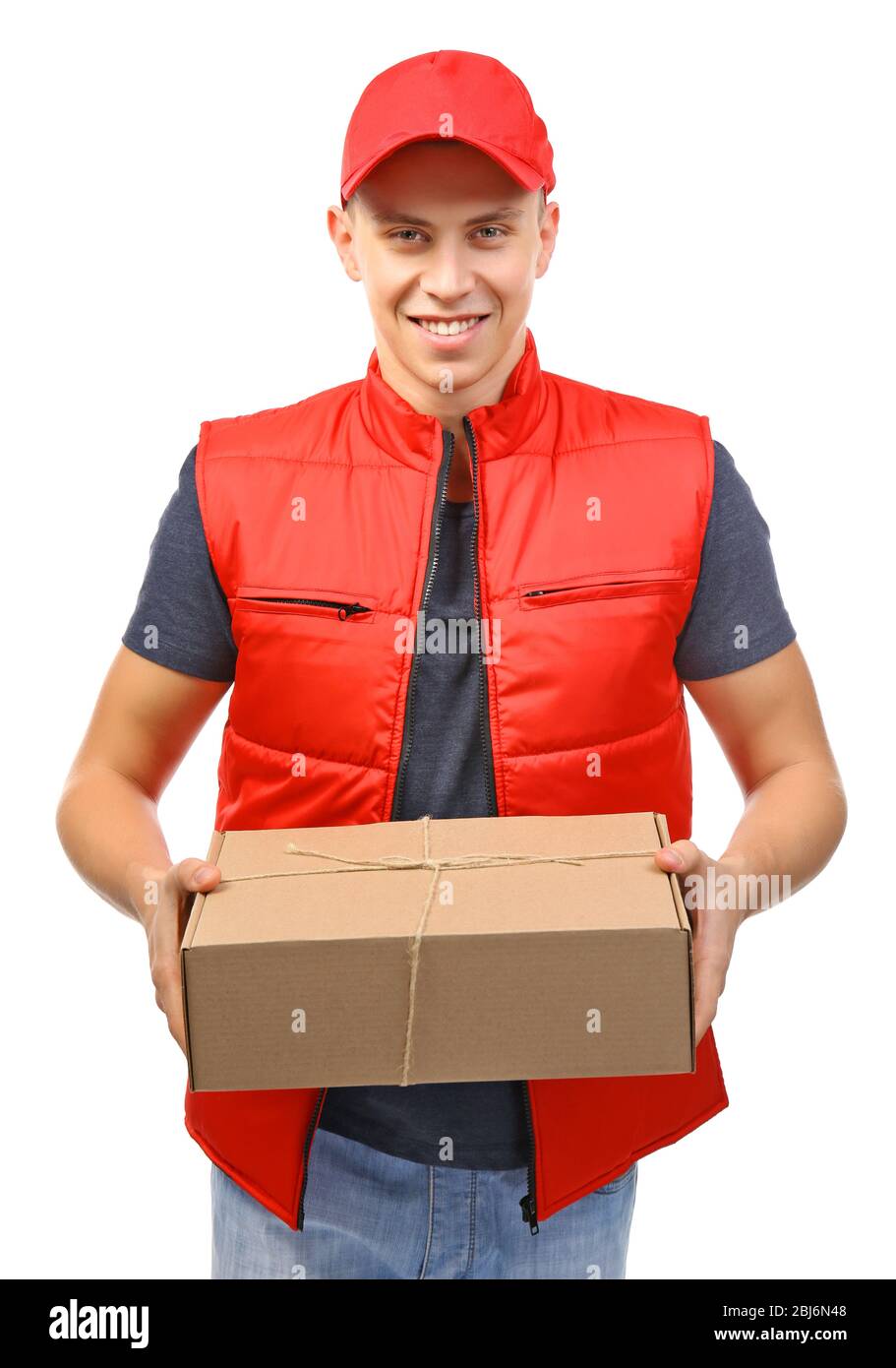 Young handsome delivery man with a carton package, isolated on white ...
