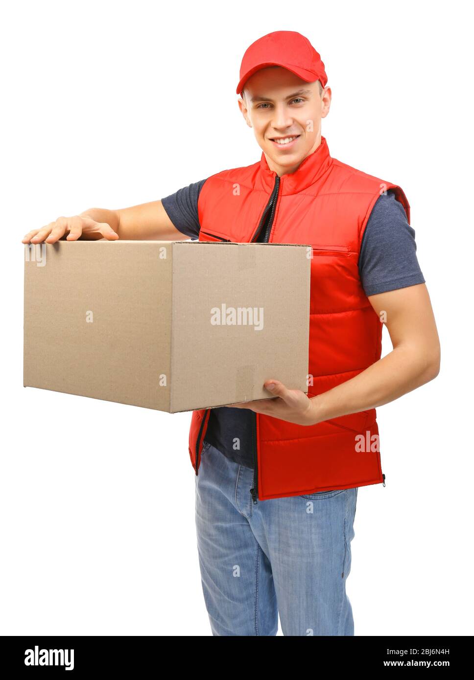 Young handsome delivery man with a carton package, isolated on white ...