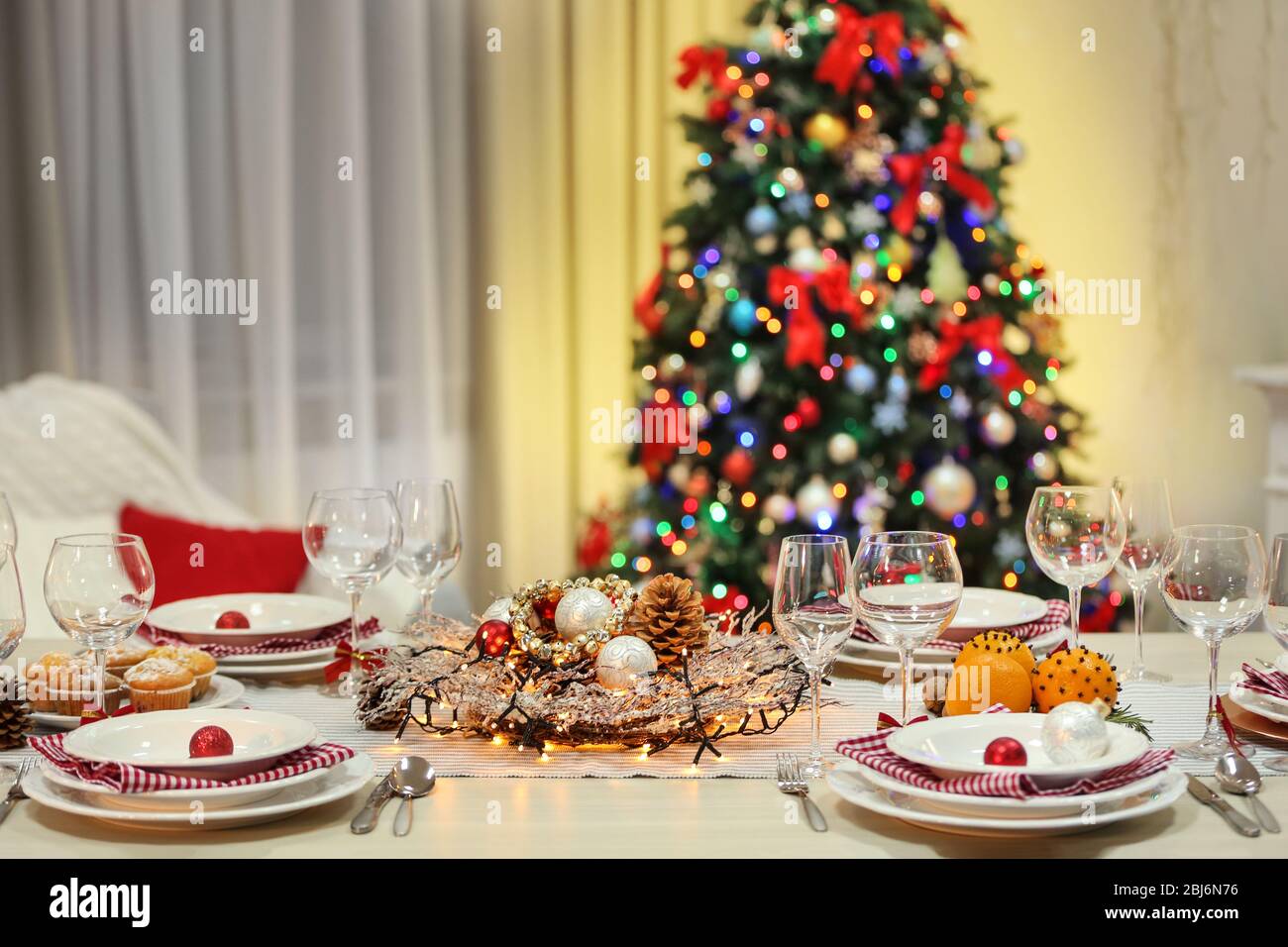 Christmas table setting with holiday decorations background Stock Photo ...