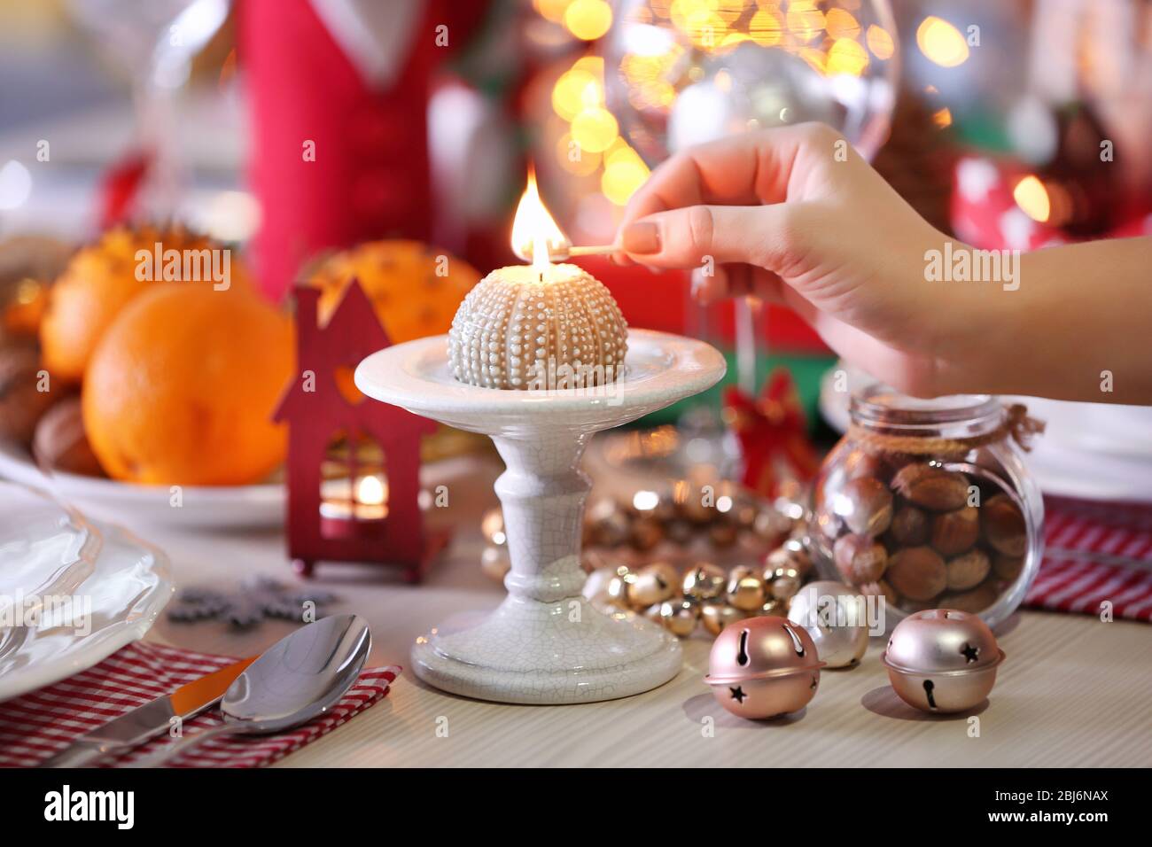 Hand lights candle on table hi-res stock photography and images - Alamy
