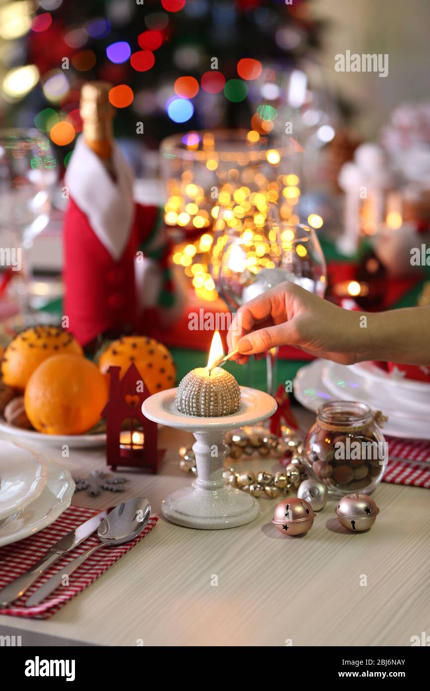 Hand lights candle on table hi-res stock photography and images - Alamy