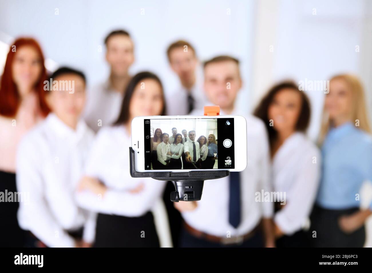 Young people making group photo with smart phone in office Stock Photo ...