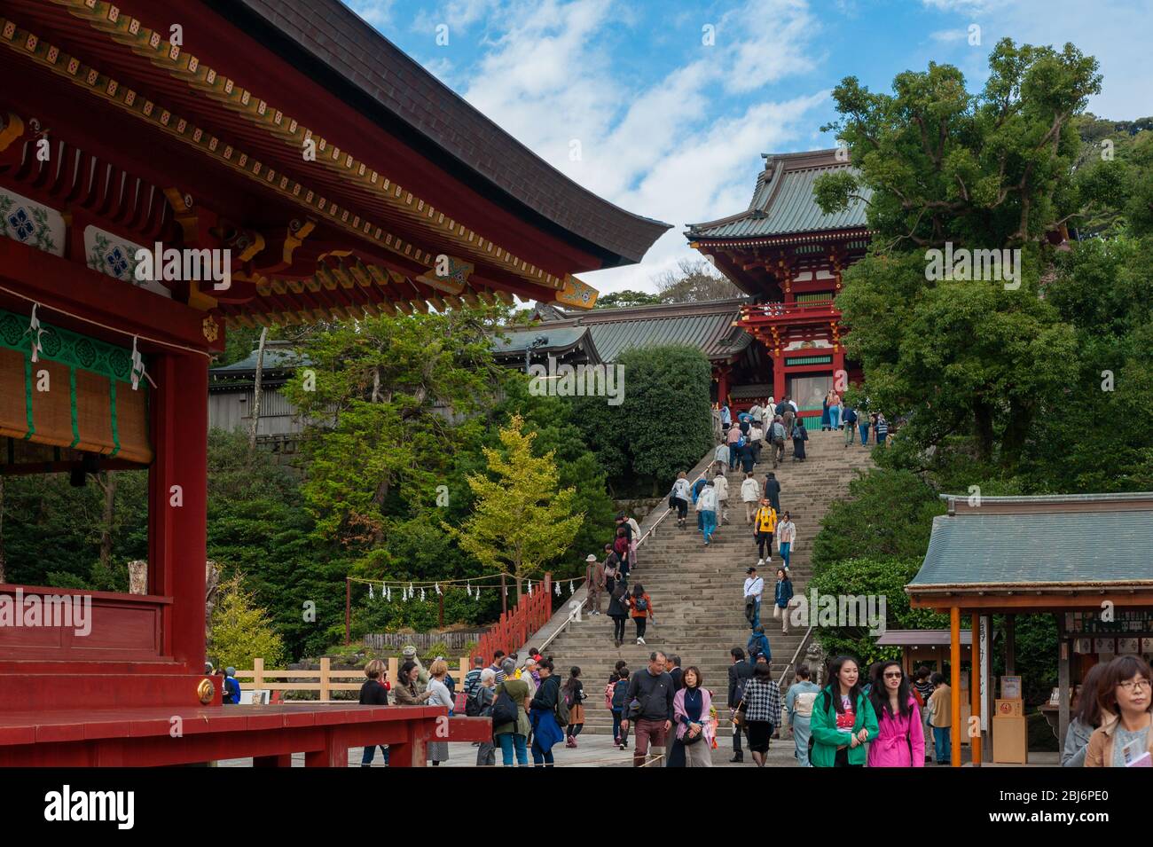 Visitors walking down the staircase at the Tsurugaoka Hachimangū temple ...